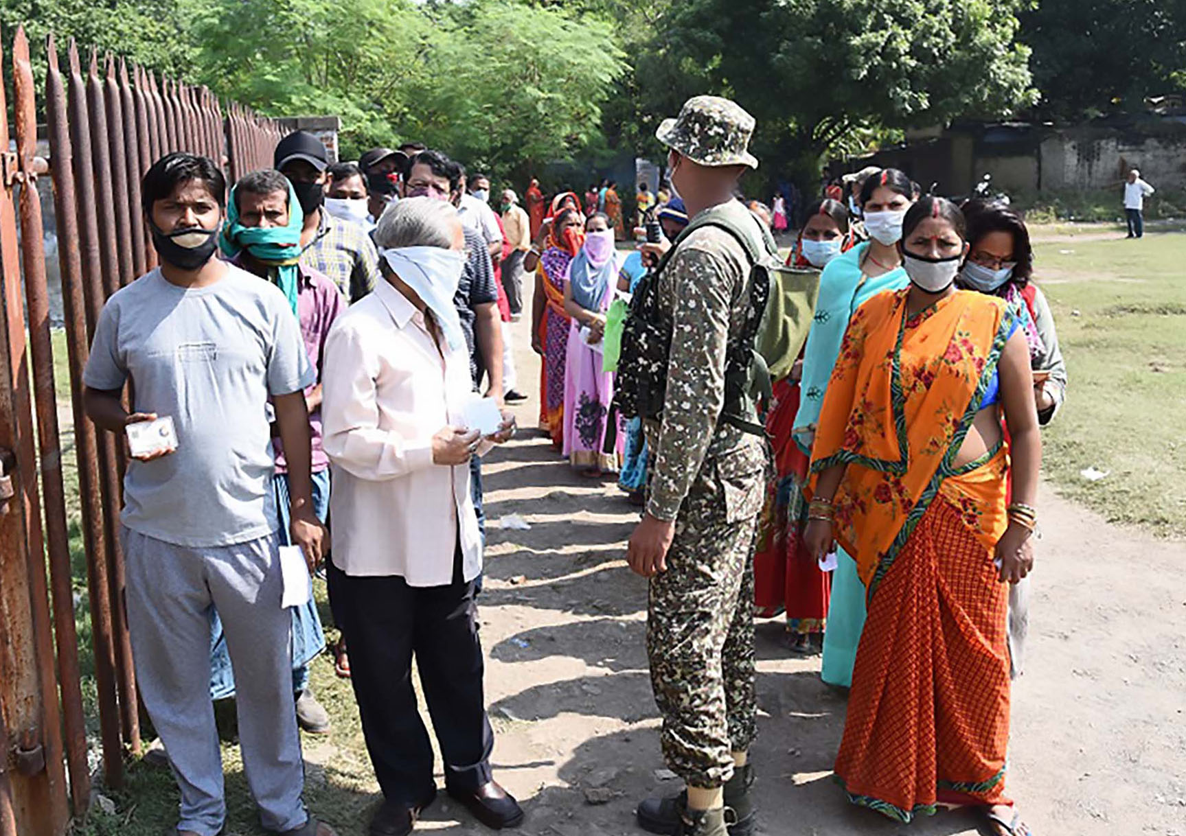 File:Voters standing in the queue to cast their votes, at a polling ...